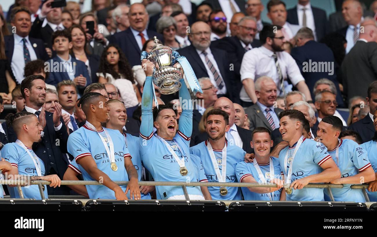 Manchester City's Jack Grealish lifts the FA Cup trophy as he ...