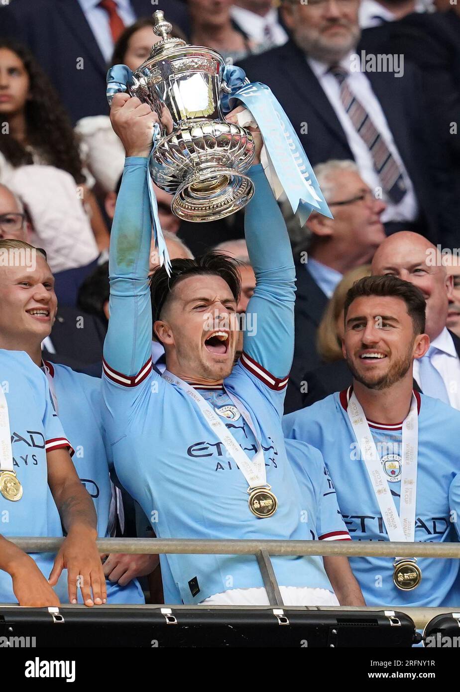 Manchester City's Jack Grealish lifts the FA Cup trophy as he ...