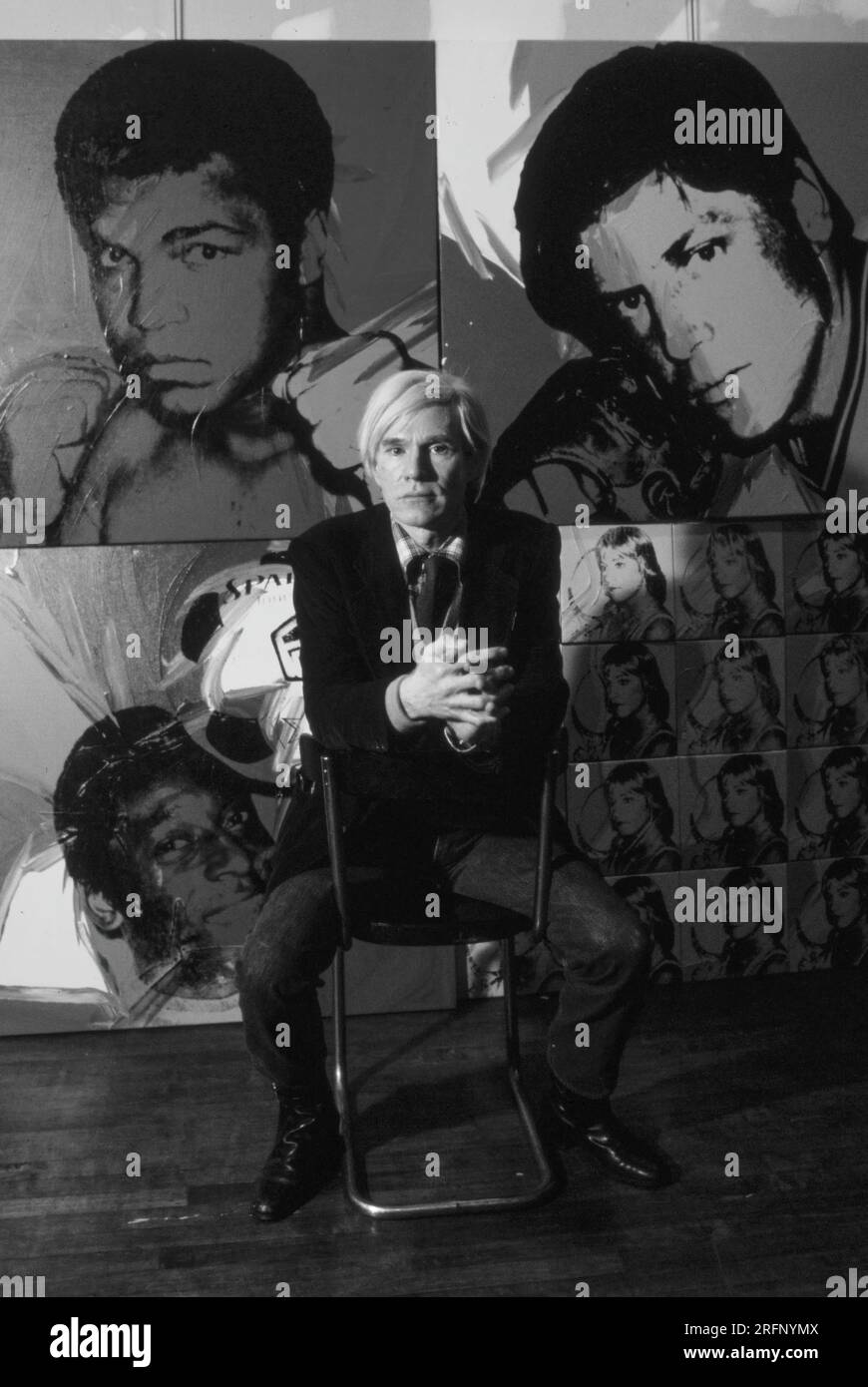 Andy Warhol in a NY gallery with his art portraits in 1975. Warhol was ...