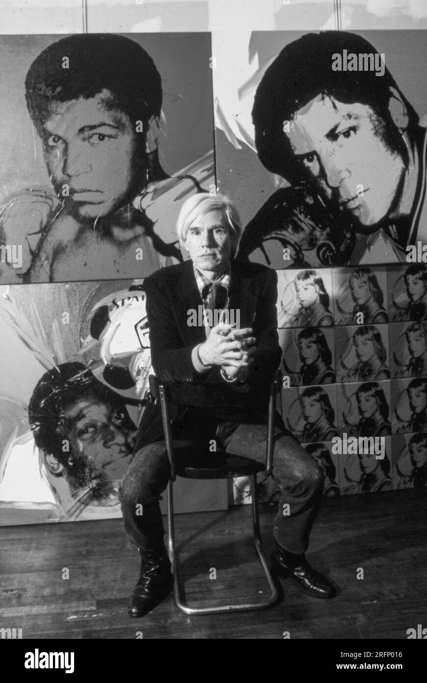 Andy Warhol in a NY gallery with his art portraits in 1975. Warhol was ...