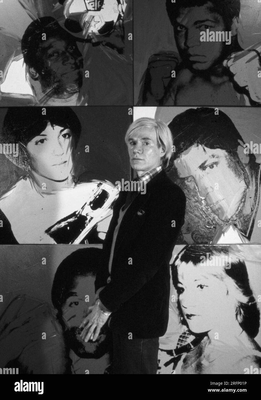 Andy Warhol in a NY gallery with his art portraits in 1975. Warhol was ...