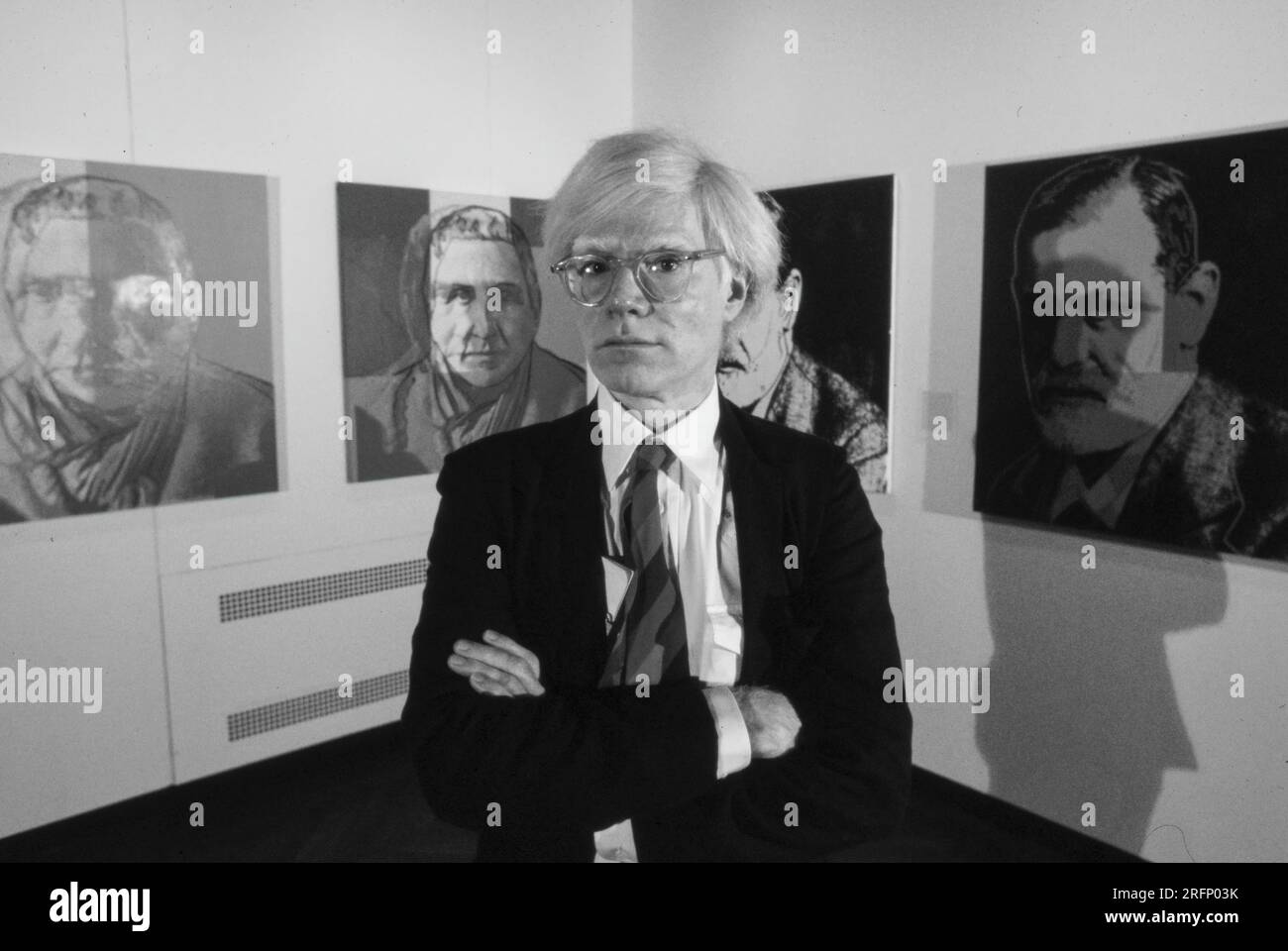 Andy Warhol in a NY gallery with his art portraits in 1975. Warhol was ...