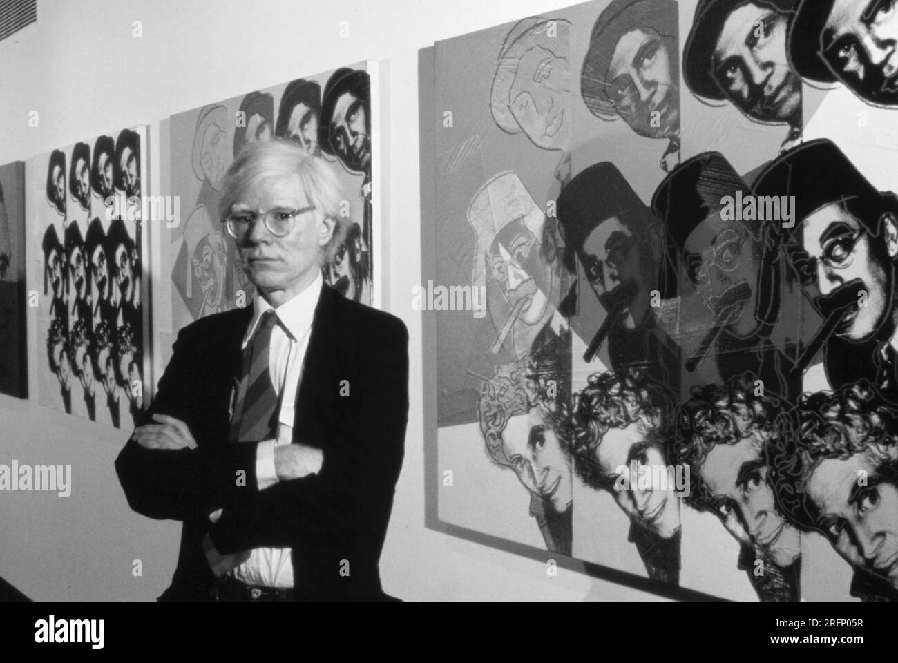 Andy Warhol in a NY gallery with his art portraits in 1975. Warhol was ...