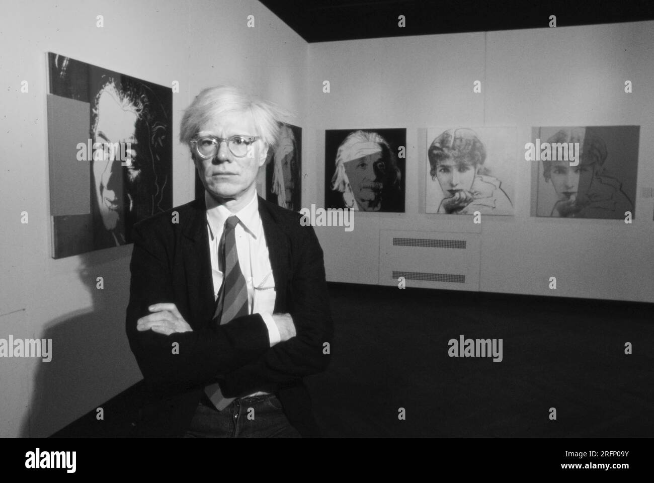 Andy Warhol in a NY gallery with his art portraits in 1975. Warhol was ...