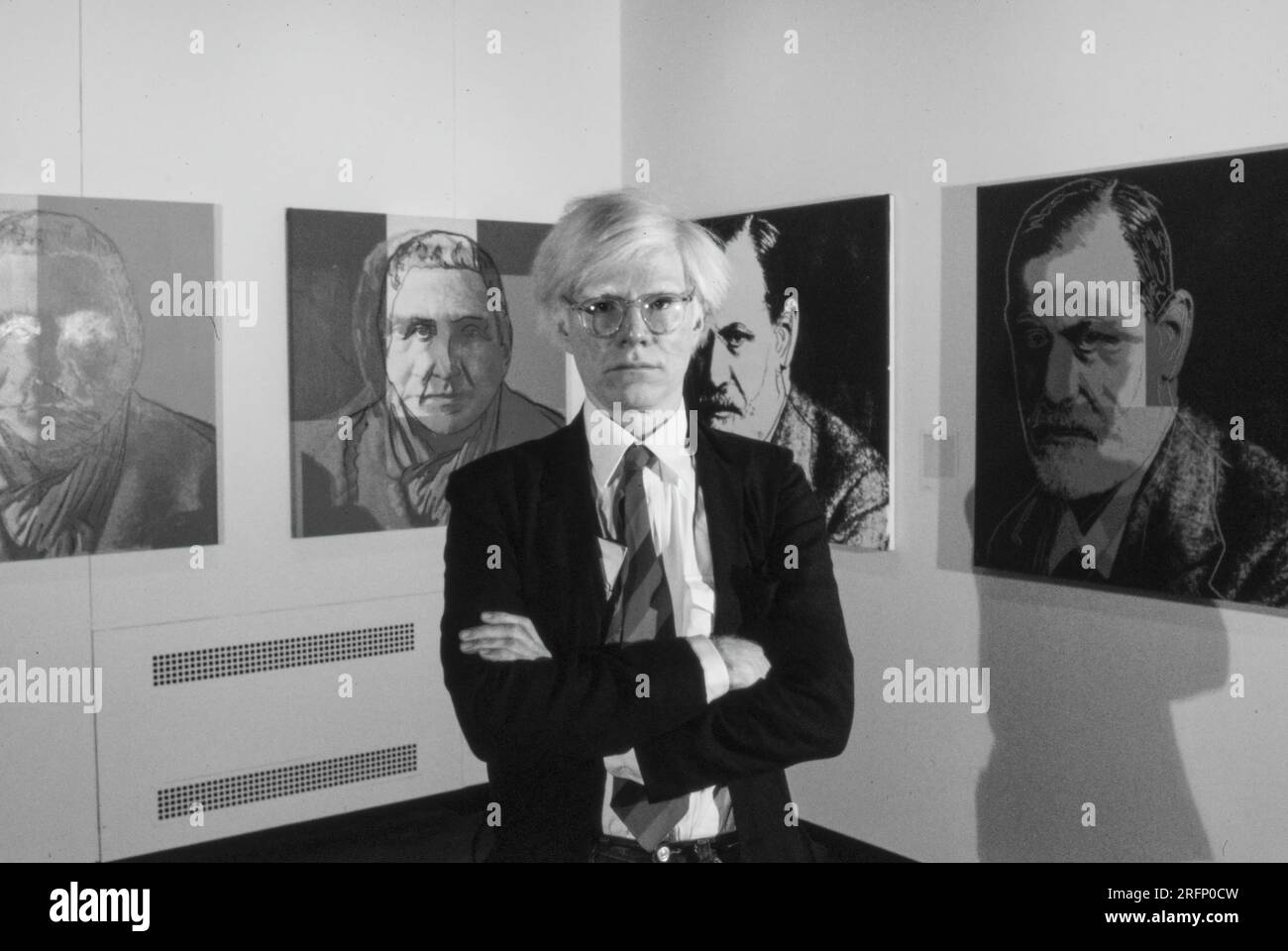 Andy Warhol in a NY gallery with his art portraits in 1975. Warhol was ...