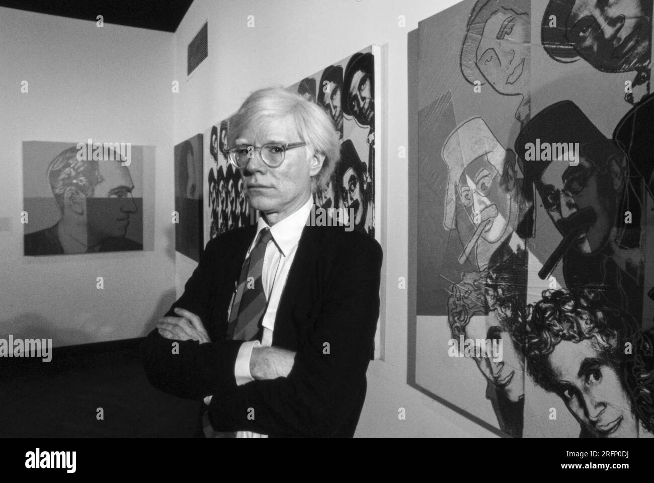 Andy Warhol in a NY gallery with his art portraits in 1975. Warhol was ...