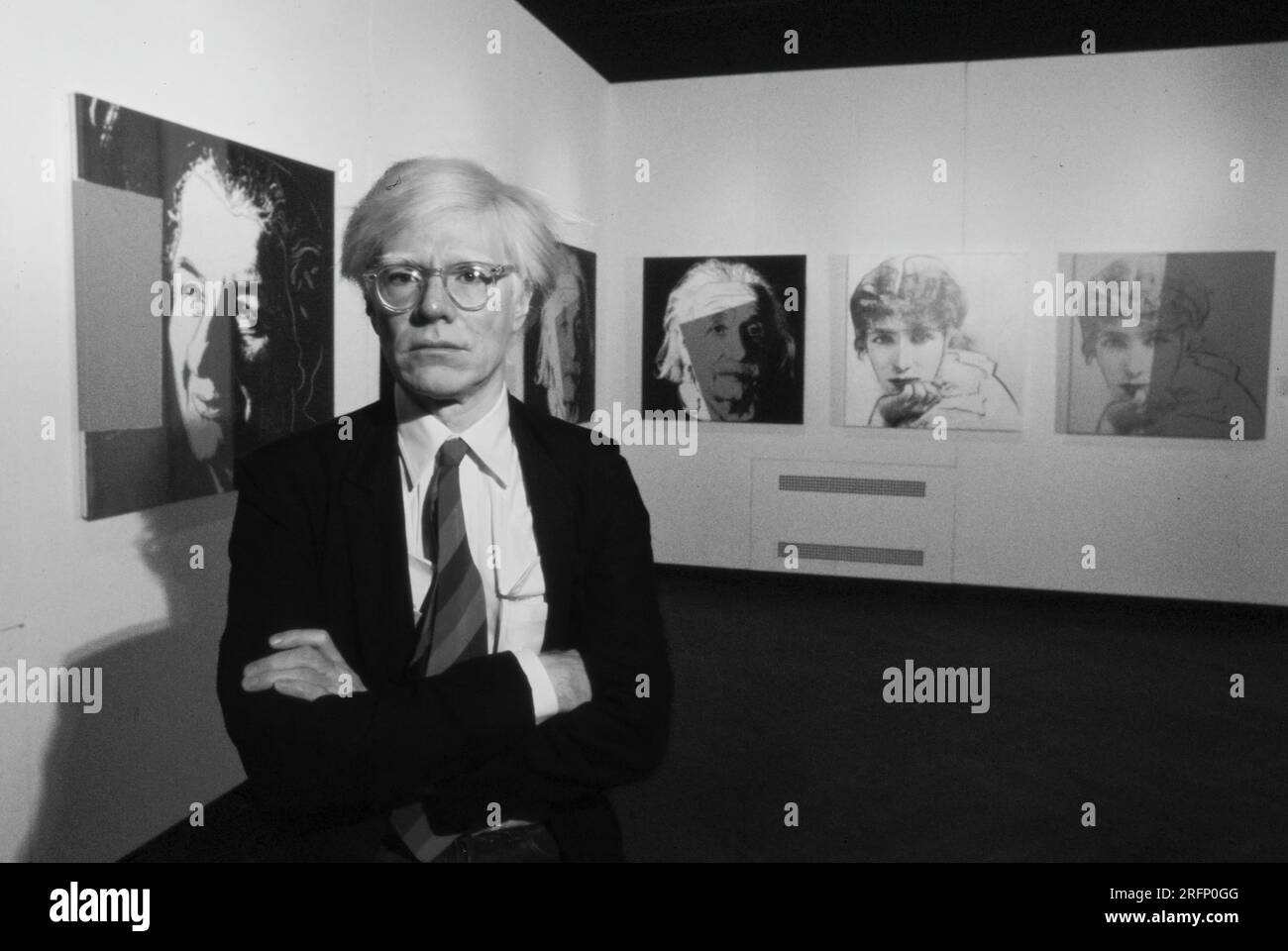 Andy Warhol in a NY gallery with his art portraits in 1975. Warhol was ...