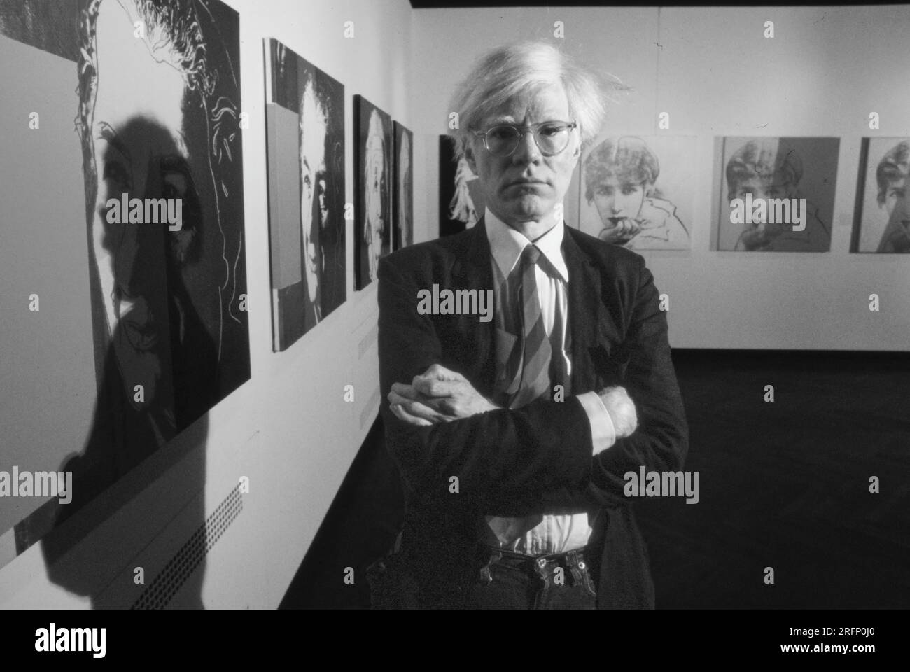 Andy Warhol in a NY gallery with his art portraits in 1975. Warhol was ...