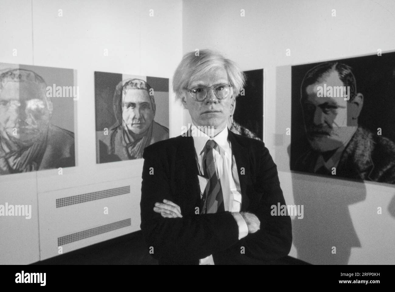Andy Warhol in a NY gallery with his art portraits in 1975. Warhol was ...