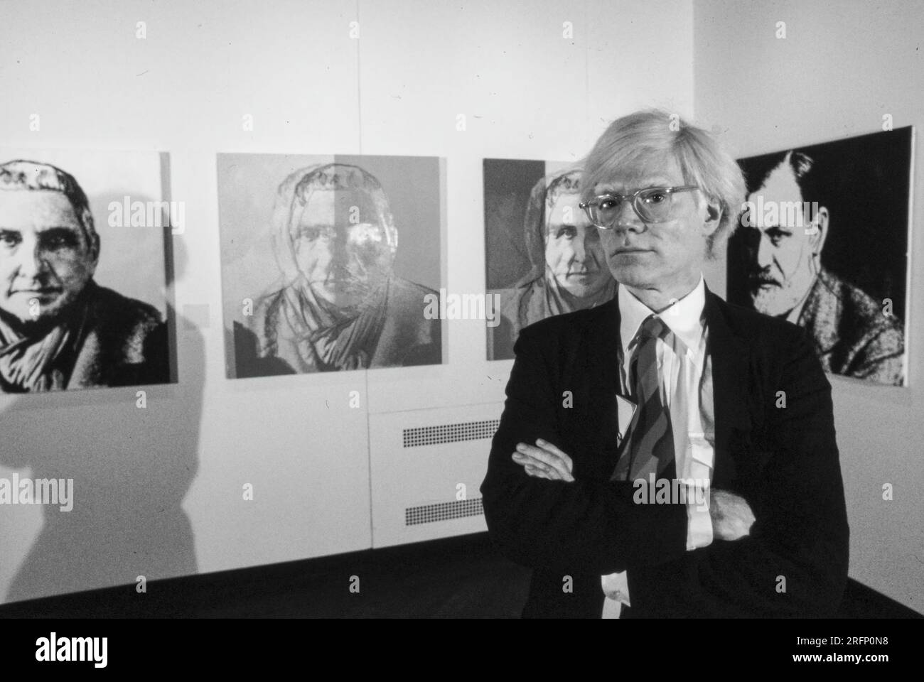Andy Warhol in a NY gallery with his art portraits in 1975. Warhol was ...