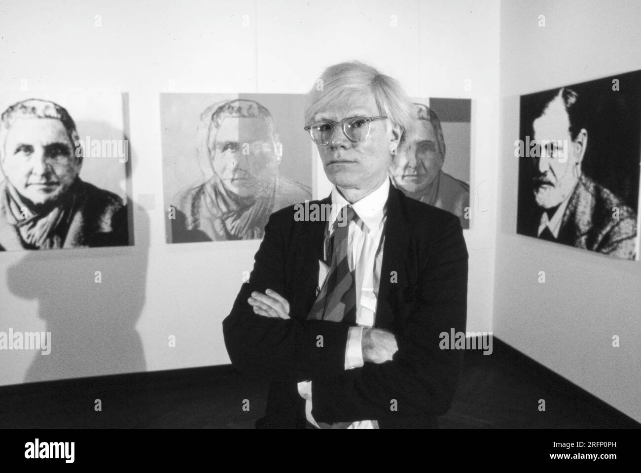 Andy Warhol in a NY gallery with his art portraits in 1975. Warhol was ...