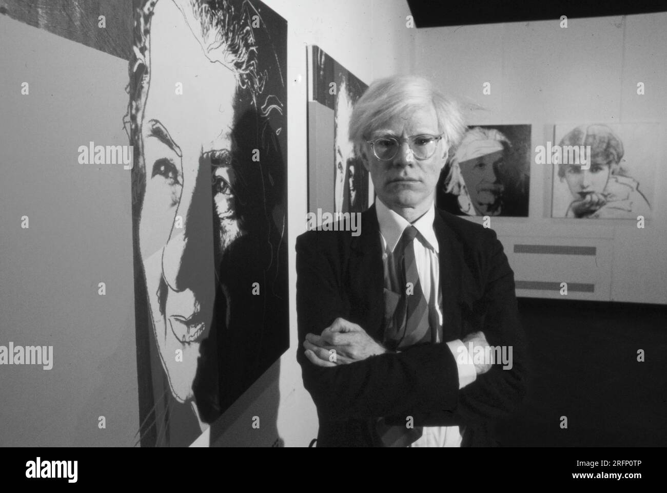 Andy Warhol in a NY gallery with his art portraits in 1975. Warhol was ...