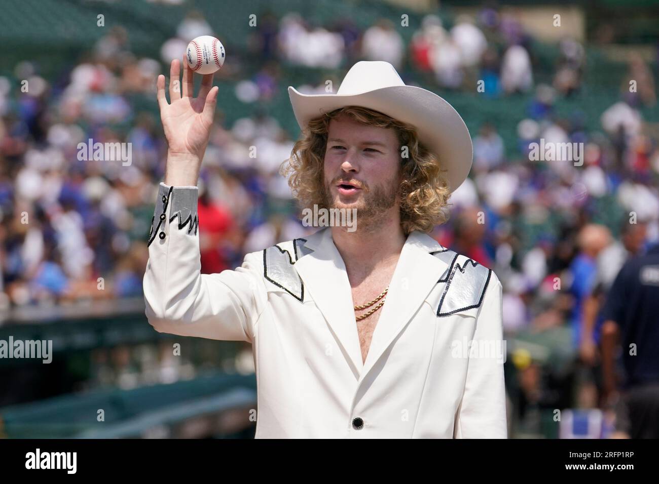 Rapper Yung Gravy warms up before throwing out a ceremonial first pitch ...