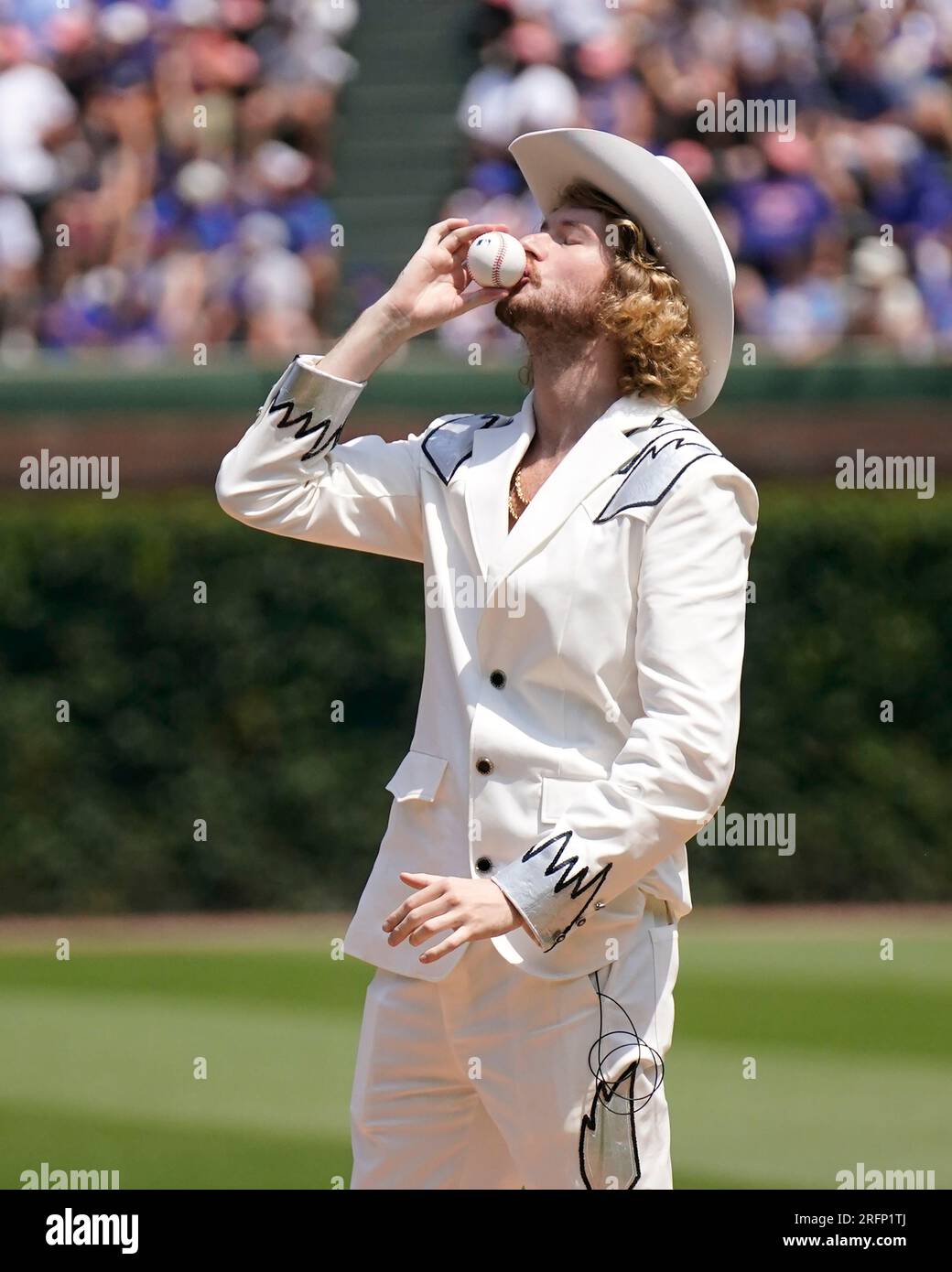 Rapper Yung Gravy kisses the baseball before throwing out a ceremonial ...
