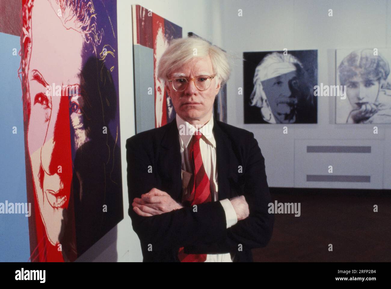 Andy Warhol in a NY gallery with his art portraits in 1975. Warhol was an American visual artist ...