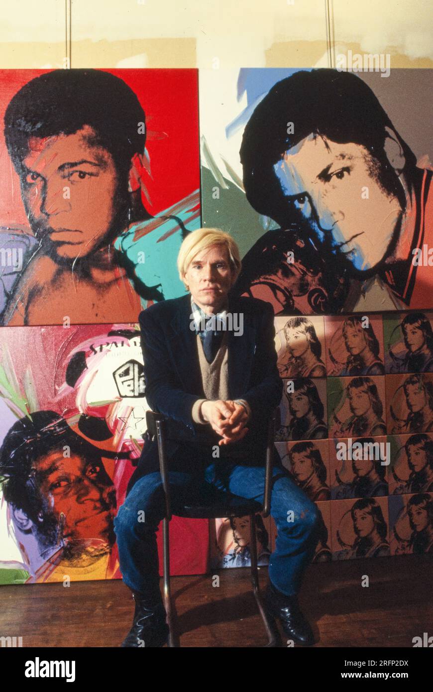 Andy Warhol in a NY gallery with his art portraits in 1975. Warhol was ...