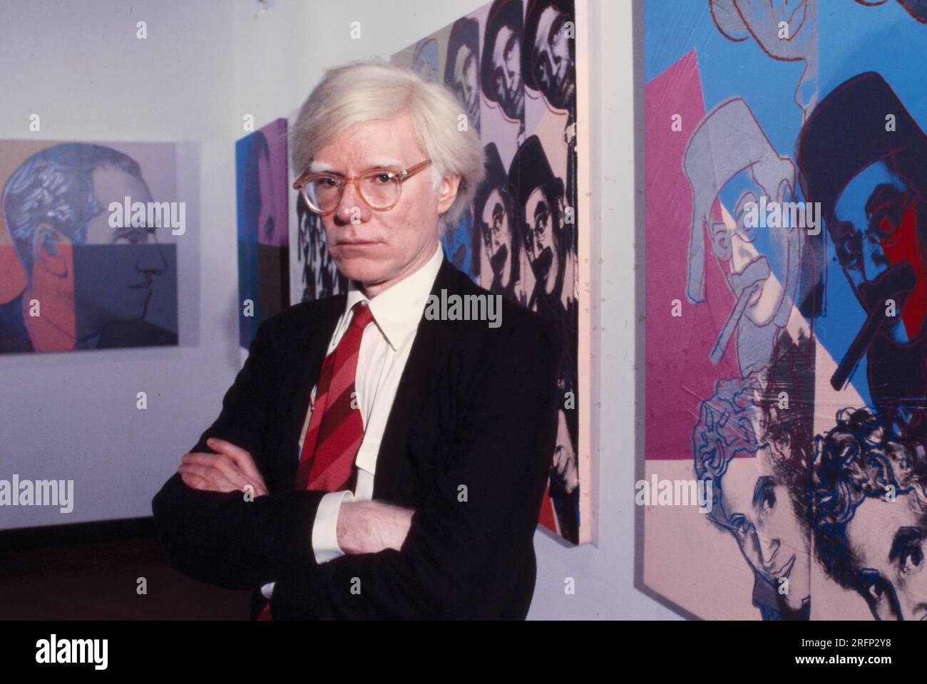 Andy Warhol in a NY gallery with his art portraits in 1975. Warhol was ...