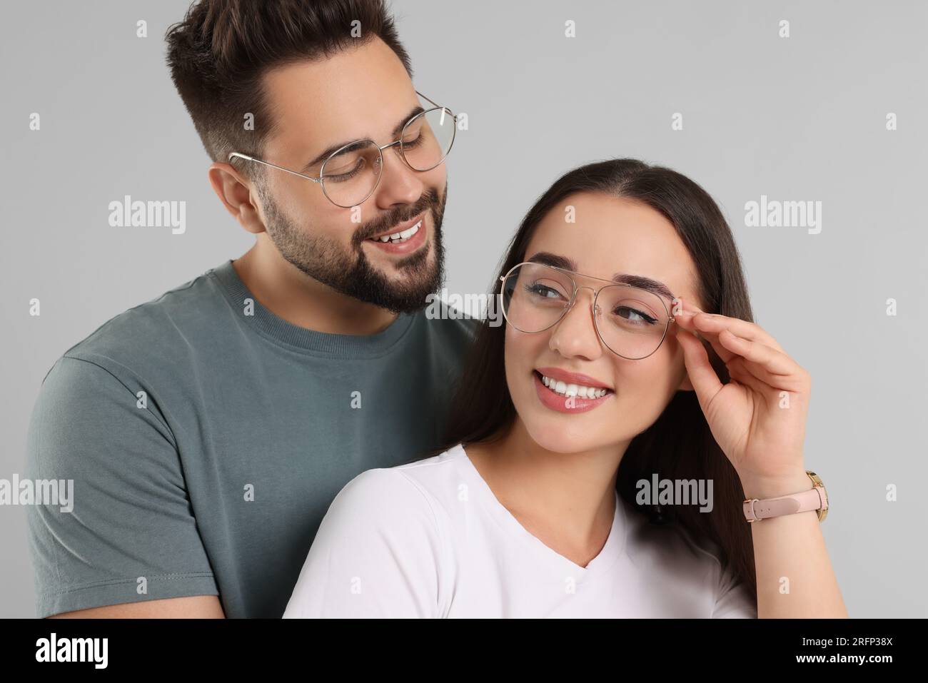 Beautiful couple wearing glasses on light gray background Stock Photo ...