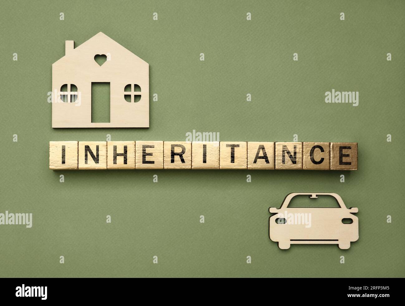 Word Inheritance made with wooden cubes, house and car models on green ...