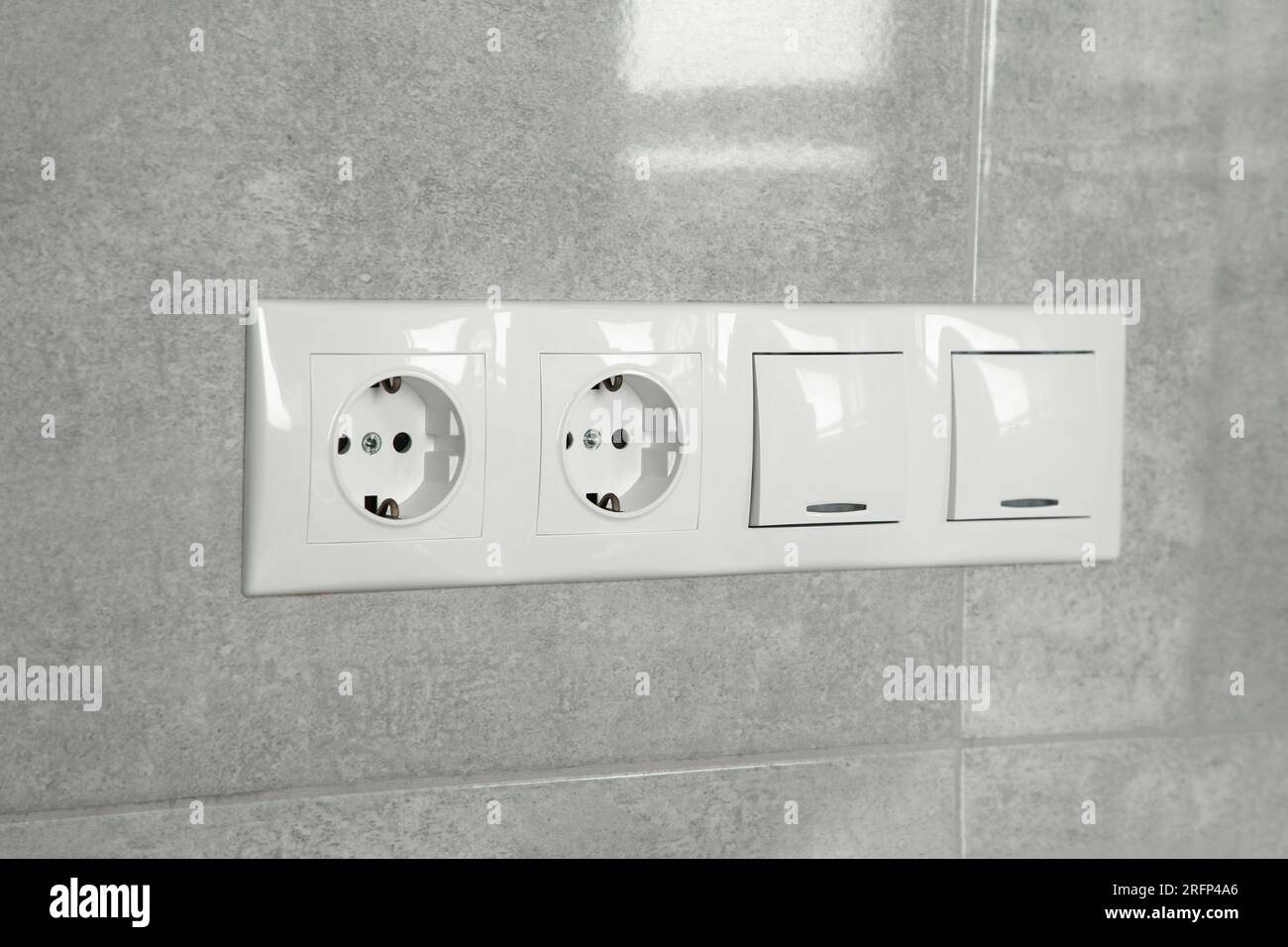 Light switches and power sockets on wall indoors Stock Photo - Alamy
