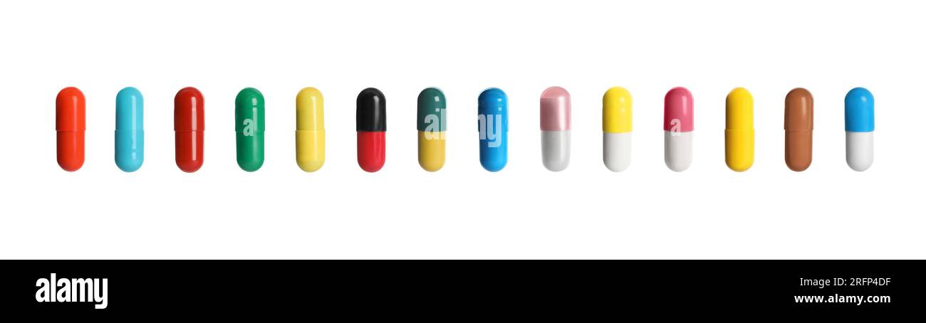Set of different color pills in row isolated on white Stock Photo - Alamy