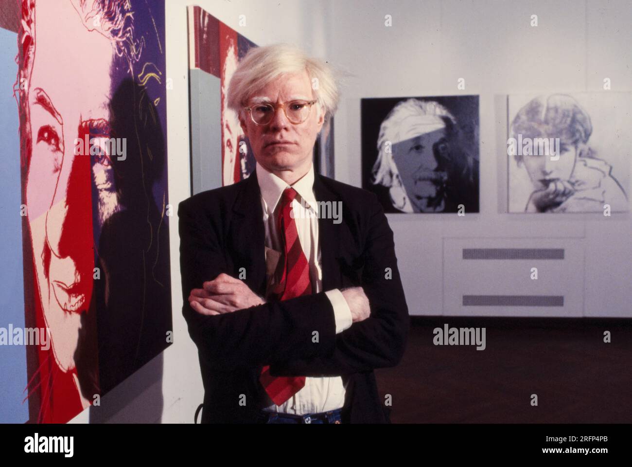 Andy Warhol in a NY gallery with his art portraits in 1975. Warhol was ...