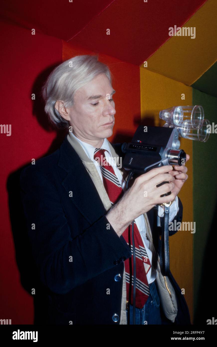 Andy Warhol with new Polaroid Polavision movie camera at an art opening ...