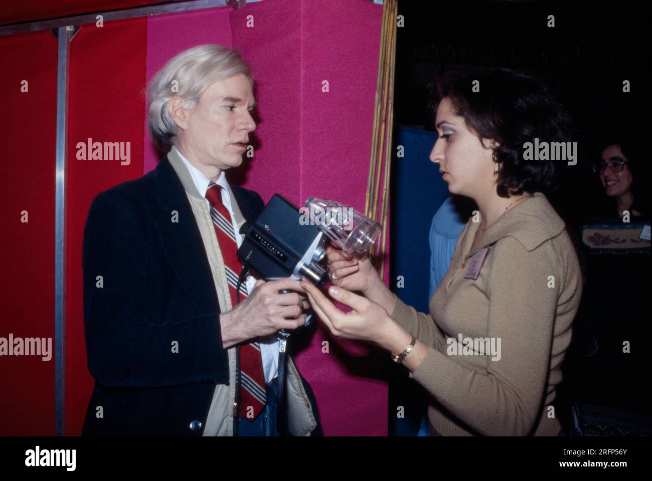 Andy Warhol with new Polaroid Polavision movie camera at an art opening ...