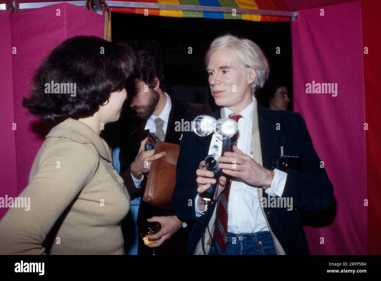 Andy Warhol with new Polaroid Polavision movie camera at an art opening ...