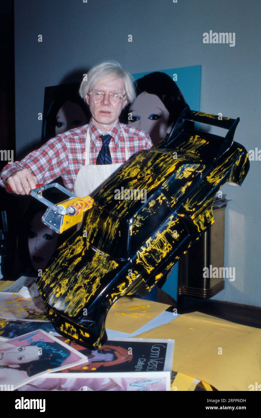 Andy Warhol paints a model car in a performance in New York in 1978 ...