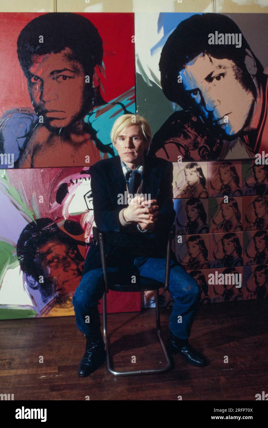 Andy Warhol in a NY gallery with his art portraits in 1975. Warhol was ...