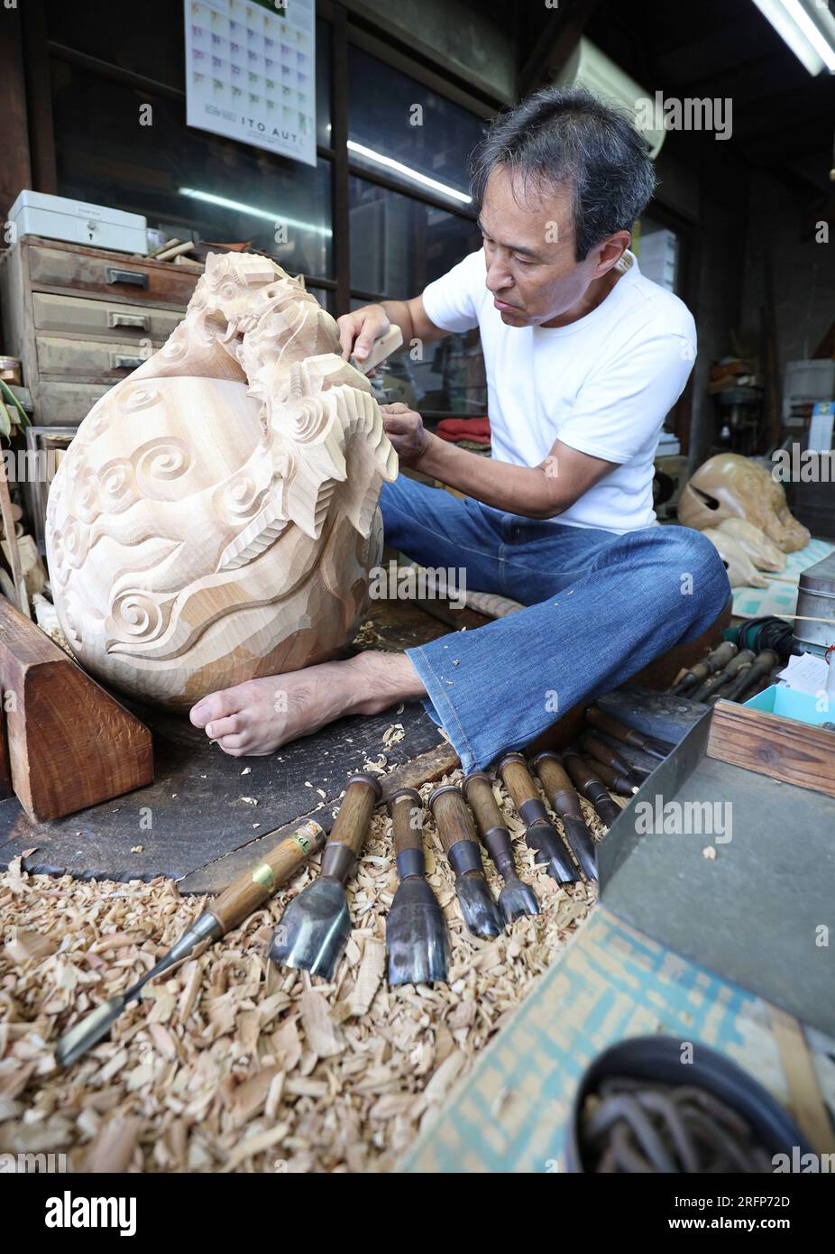 Craftsman Toshikazu Kato makes a Mokugyo, a wooden fish, at Kato ...