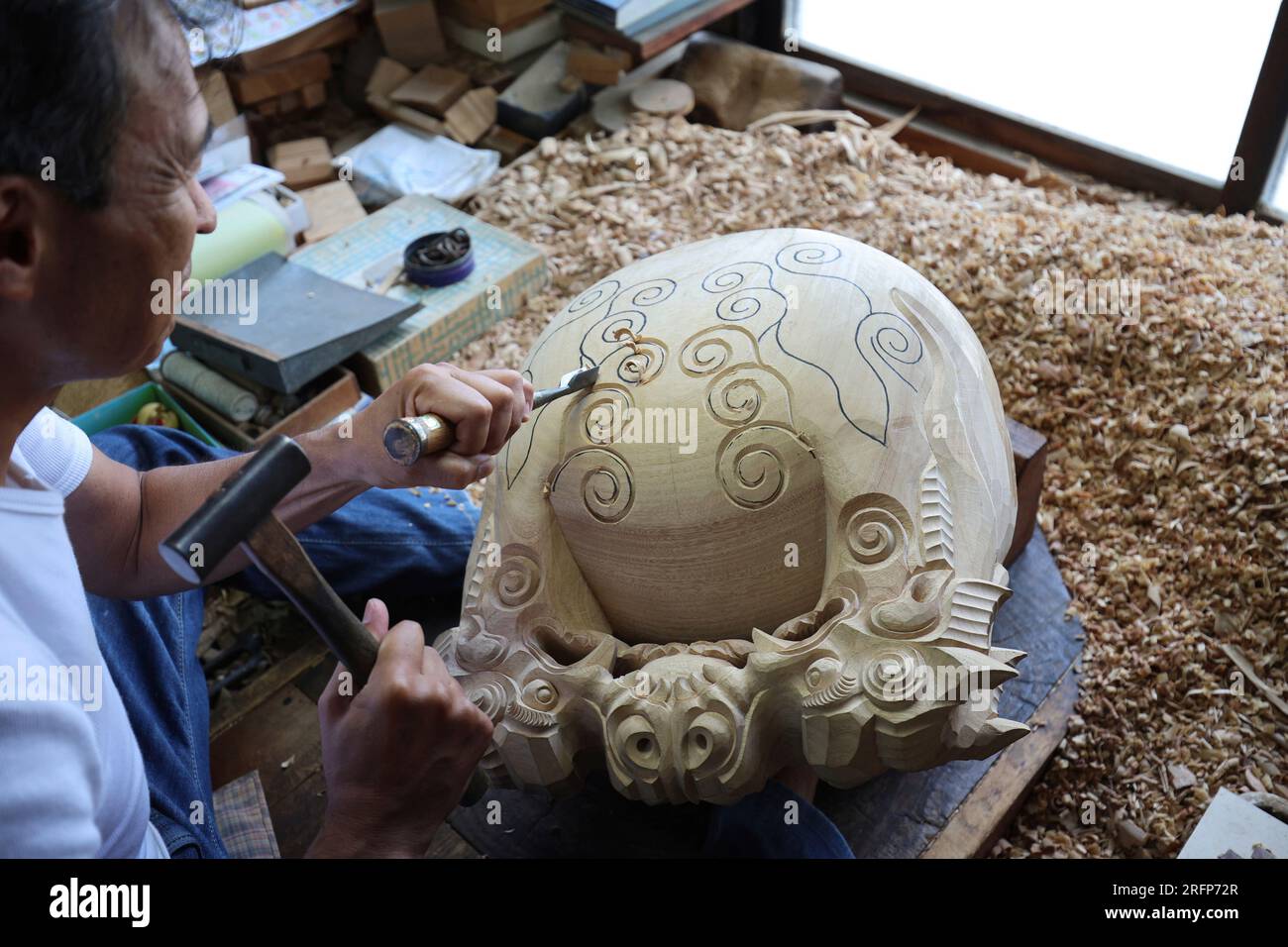 Craftsman Toshikazu Kato makes a Mokugyo, a wooden fish, at Kato ...
