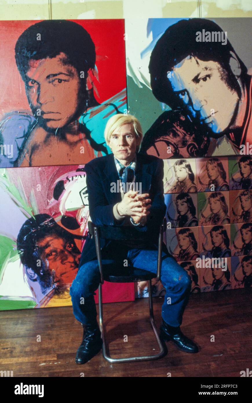 Andy Warhol in a NY gallery with his art portraits in 1975. Warhol was ...