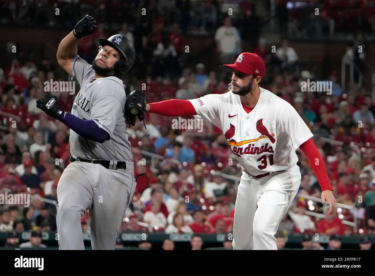Colorado Rockies' Elias Diaz, left, is tagged out by St. Louis ...