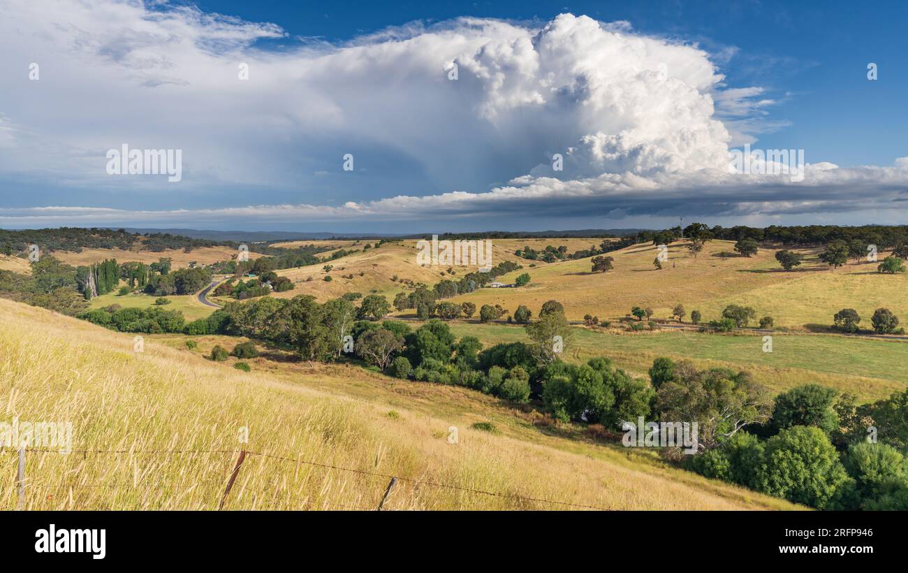A dramatic thunderstorm developing over a rural valley at Guildford in ...