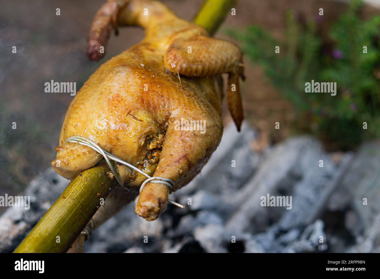 spit roasted chicken over coals Stock Photo - Alamy