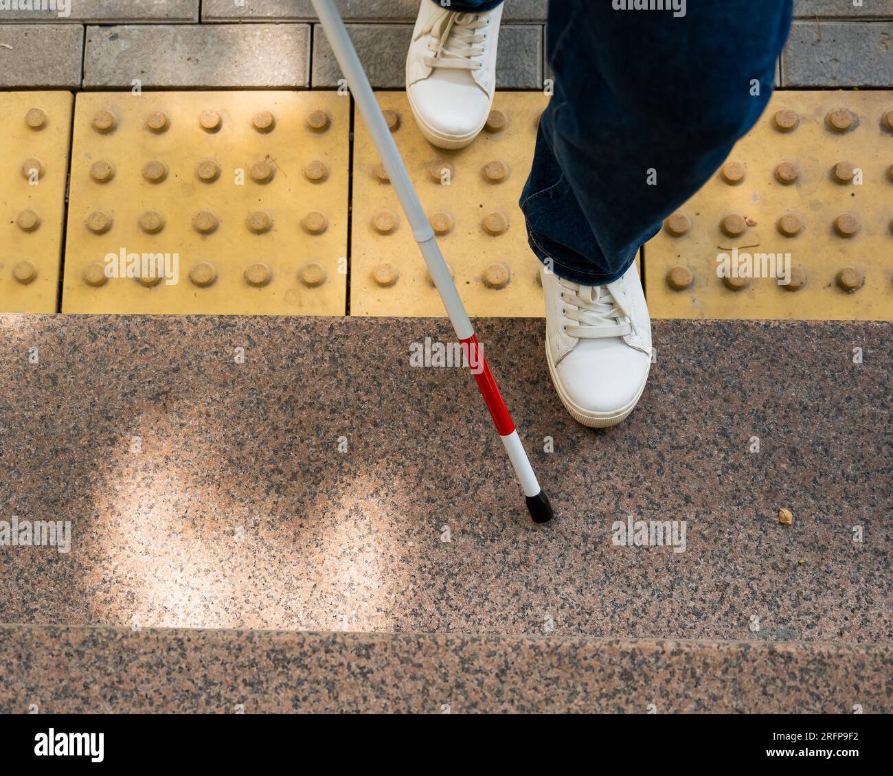 Close-up of female foot, walking stick and tactile tiles Stock Photo ...