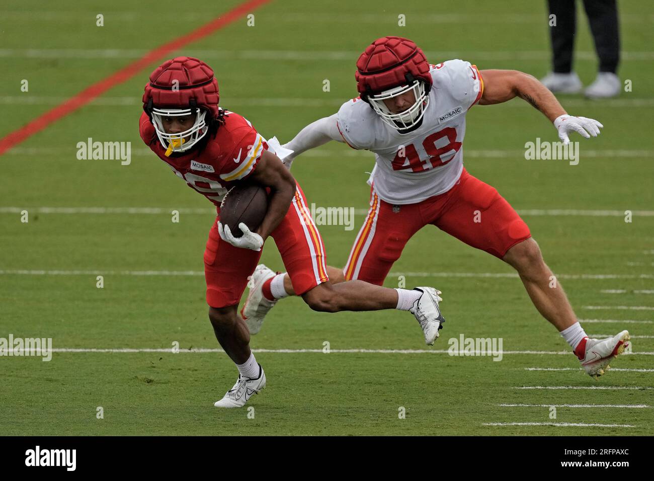 Kansas City Chiefs wide receiver Jerrion Ealy, left, is chased by ...
