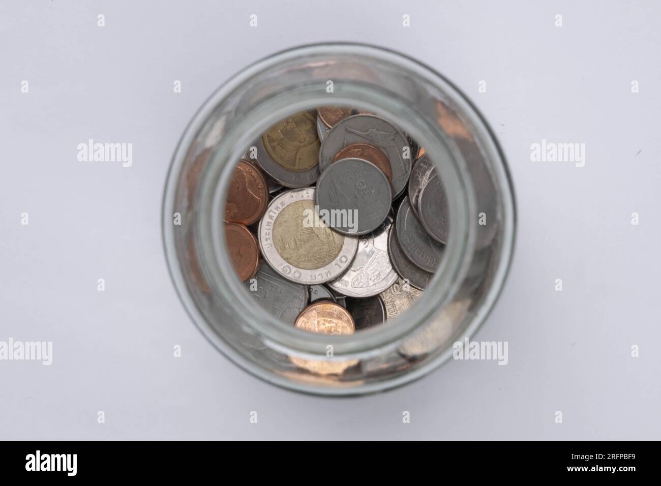 Top view of coins fill a glass jar. Video of coins falling into a clear ...