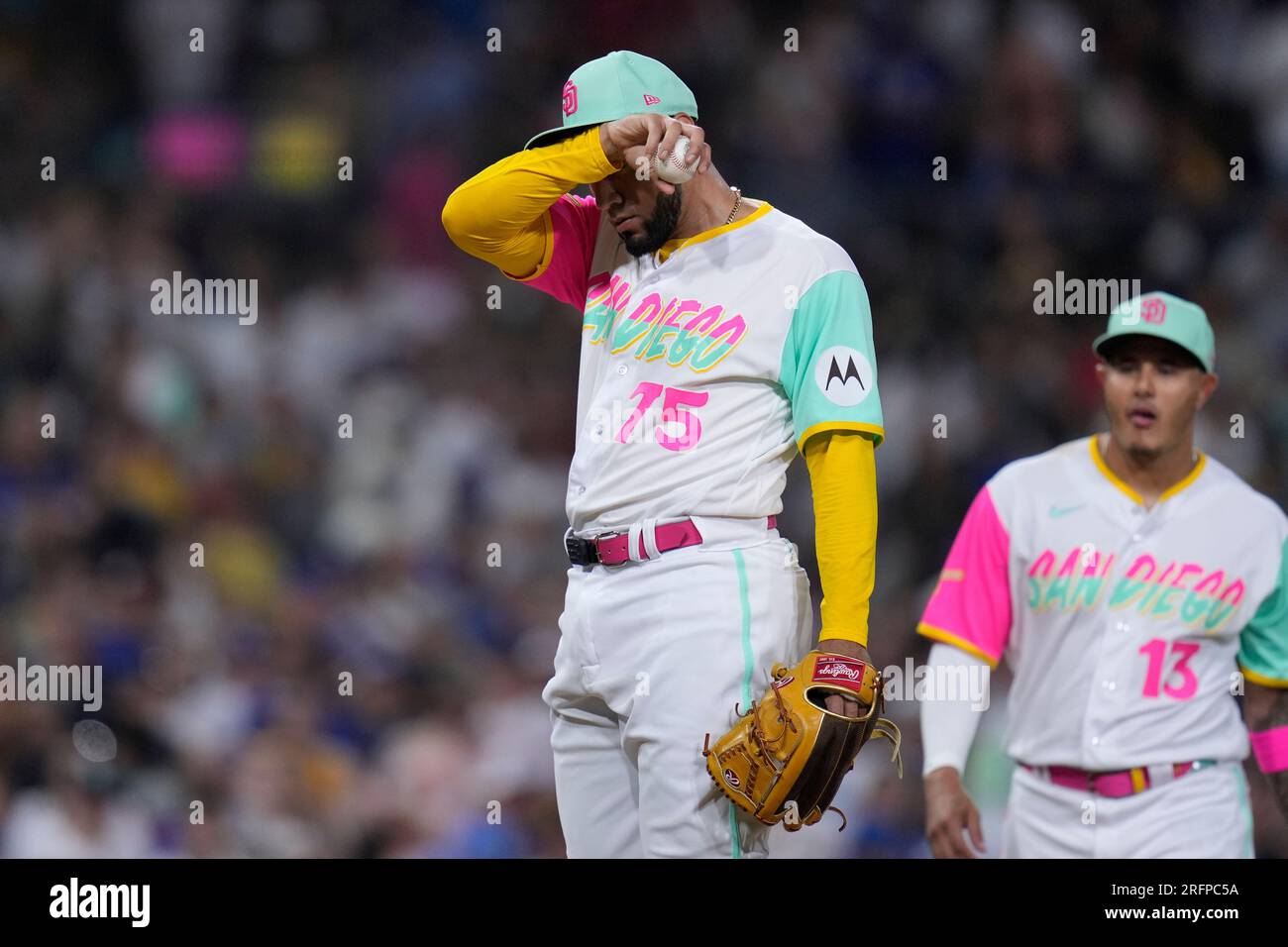 San Diego Padres relief pitcher Robert Suarez (75) wipes his face ...