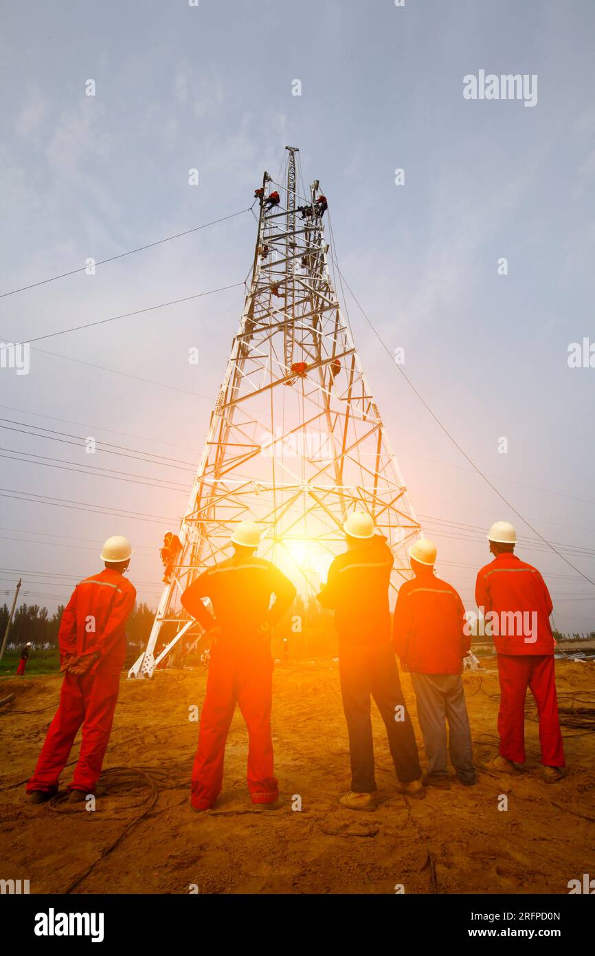 The workers of the pylon Stock Photo - Alamy