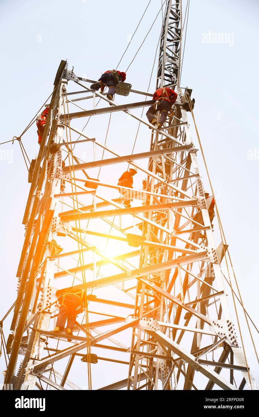 The workers of the pylon Stock Photo - Alamy