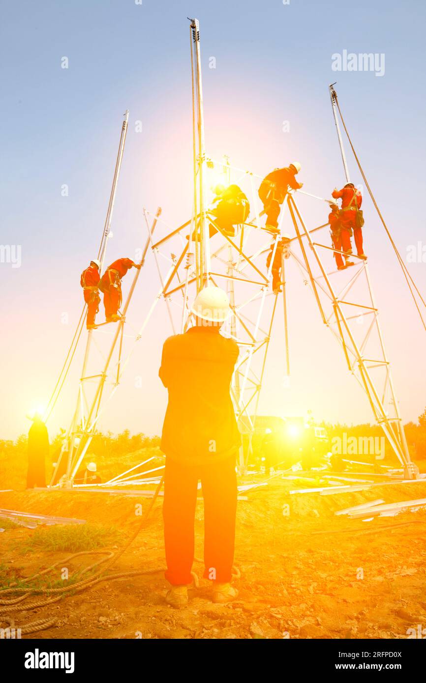 The workers of the pylon Stock Photo - Alamy