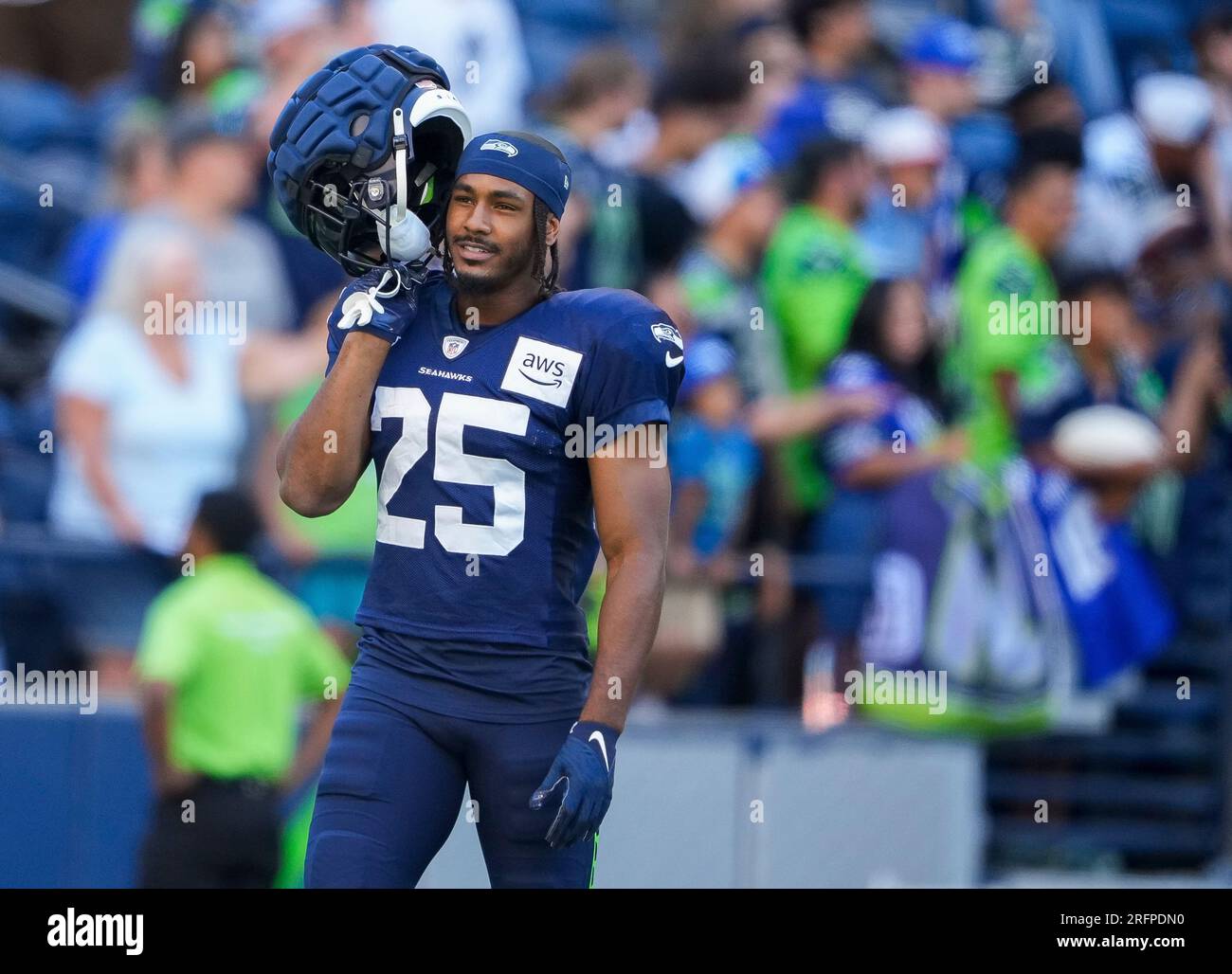 Seattle Seahawks running back Kenny McIntosh (25) holds his helmet on ...