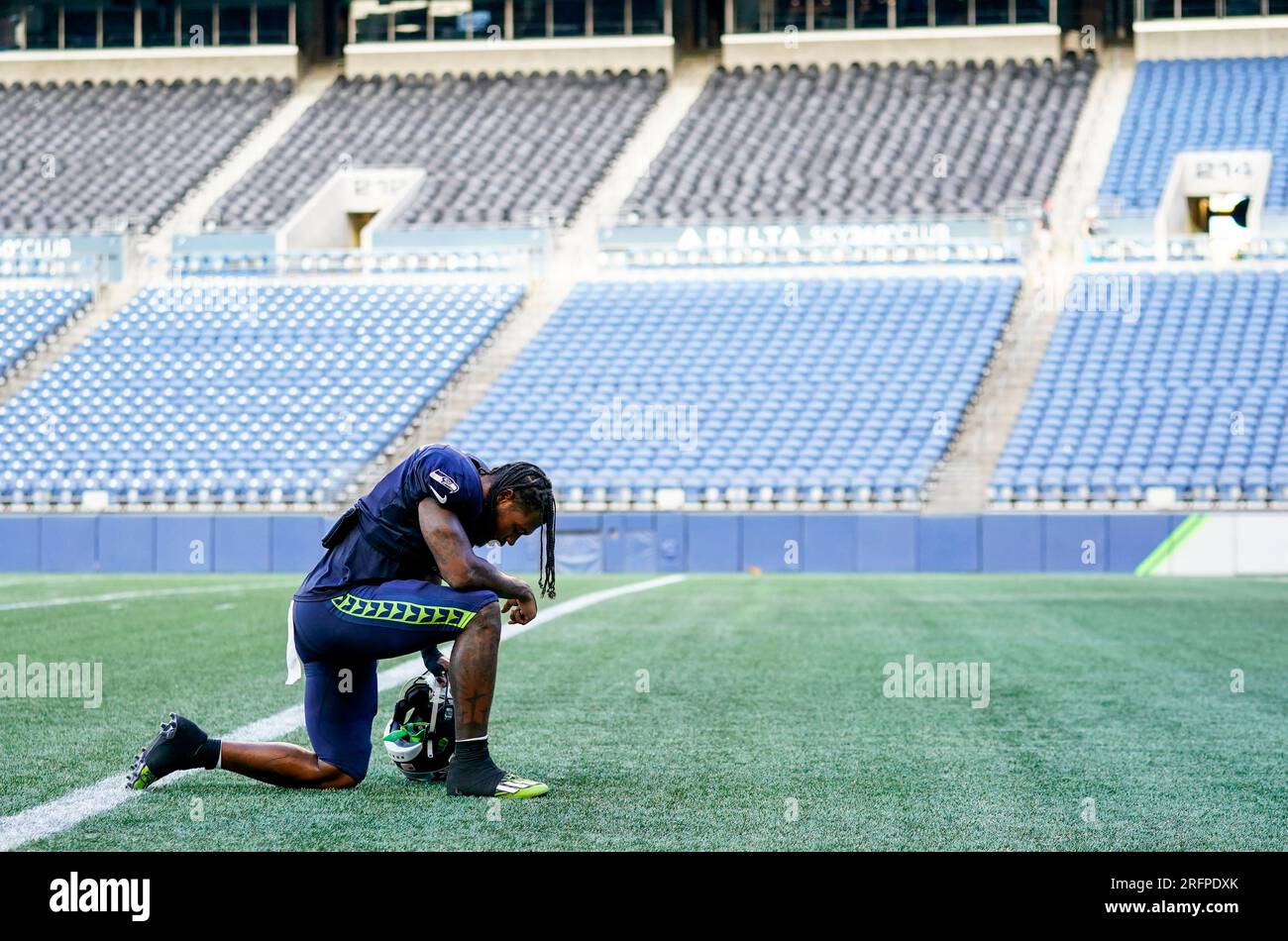 Seattle Seahawks wide receiver Dee Eskridge kneels on the field ...