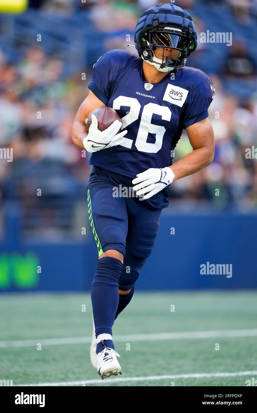 Seattle Seahawks running back Zach Charbonnet carries the ball before ...