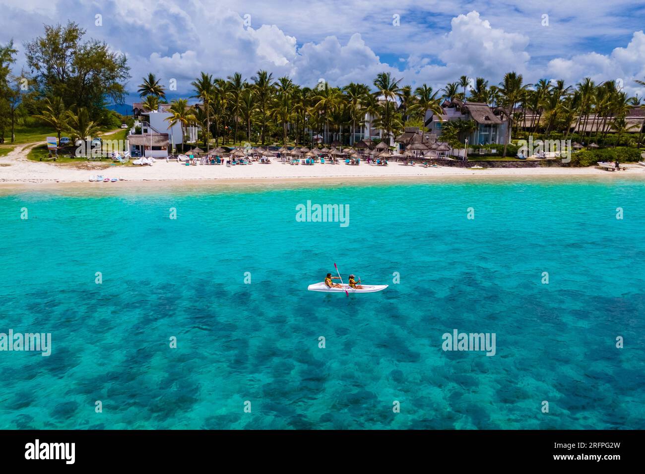 Mauritius vacation, couple man and woman in a kayak in a blue ocean in ...