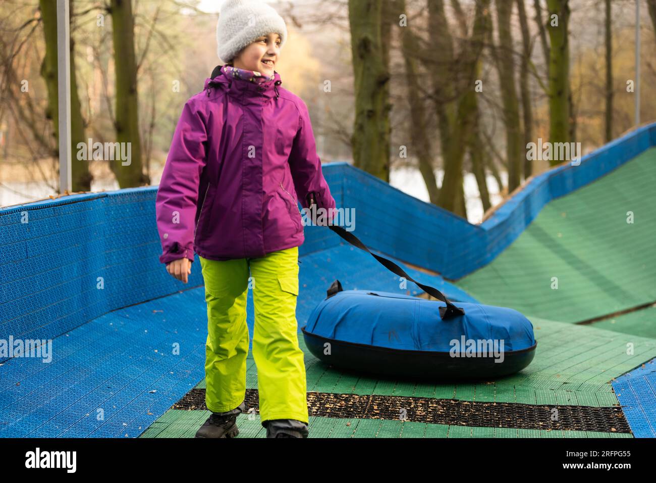 a little kid enjoying tubing down the wavy track ski resort Stock Photo ...
