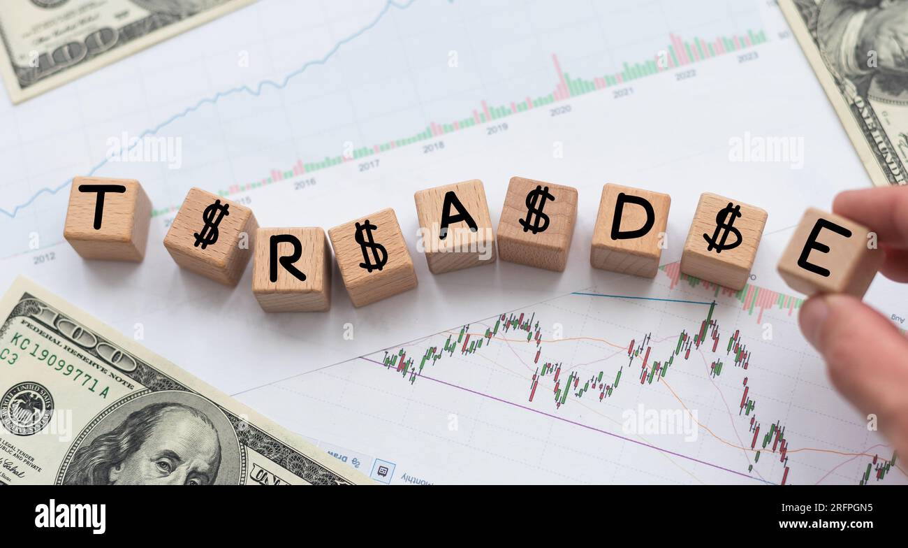 Businessman hand holding wooden cube block with TRADER business word on ...